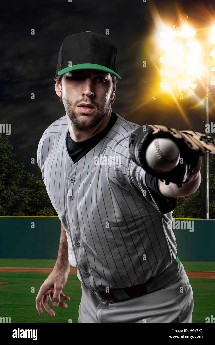 Baseball Player on a Green Uniform on baseball Stadium Stock Photo - Alamy