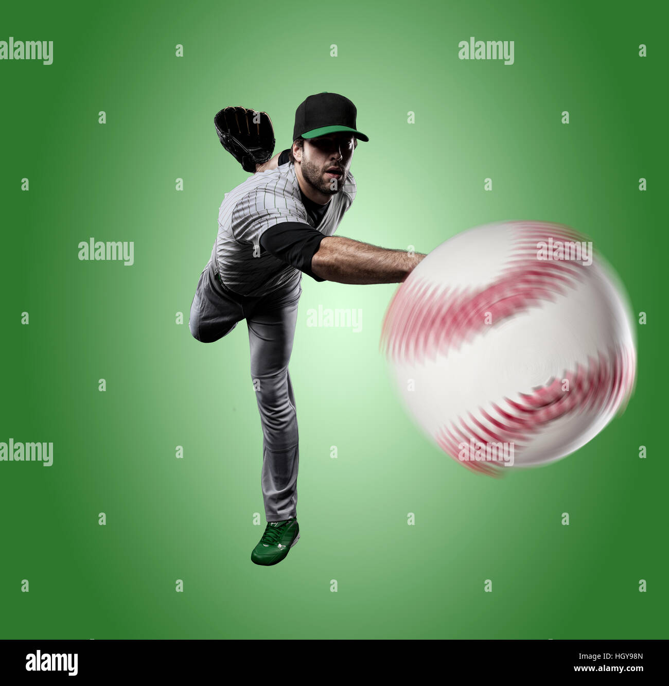 Pitcher Baseball Player on a Green Uniform on Green background Stock ...