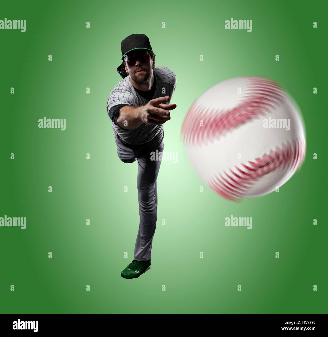 Pitcher Baseball Player on a Green Uniform on Green background Stock ...