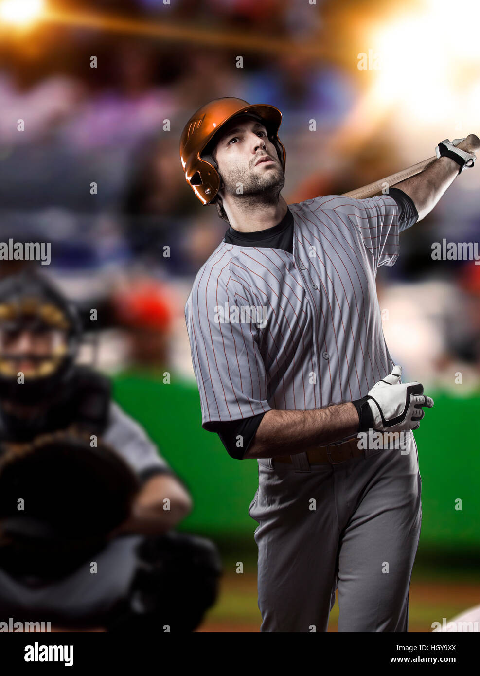Baseball Player on a Orange Uniform on baseball Stadium Stock Photo - Alamy