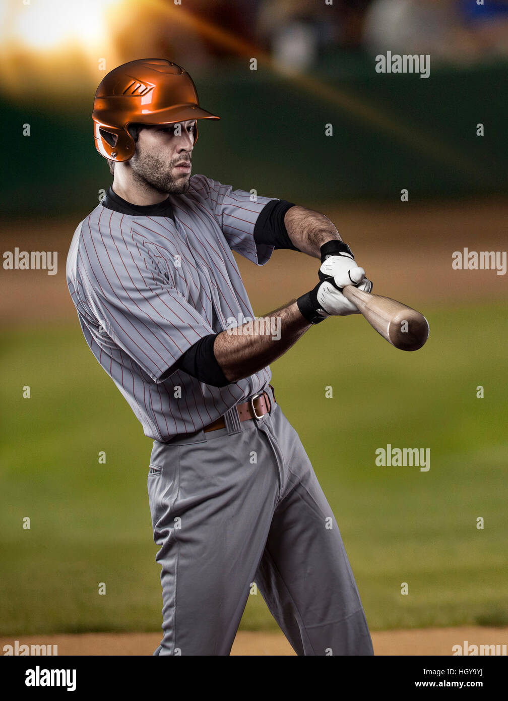 Baseball Player on a Orange Uniform on baseball Stadium Stock Photo - Alamy