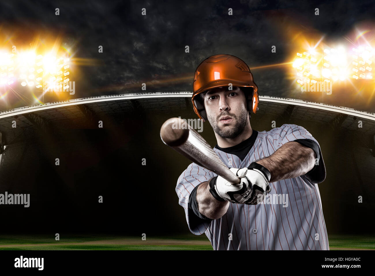 Baseball Player on a Orange Uniform on baseball Stadium Stock Photo - Alamy