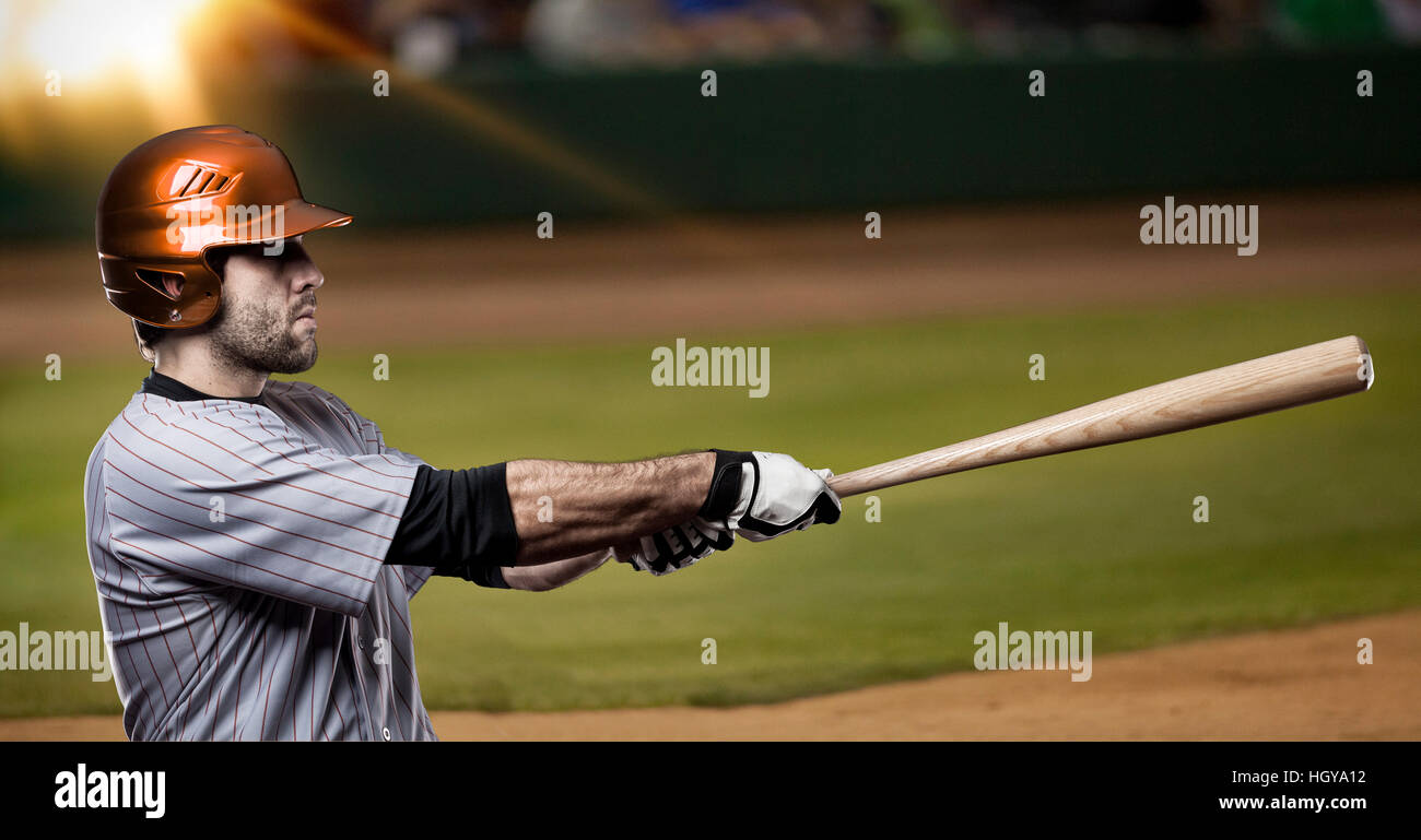 Baseball Player on a Orange Uniform on baseball Stadium Stock Photo - Alamy