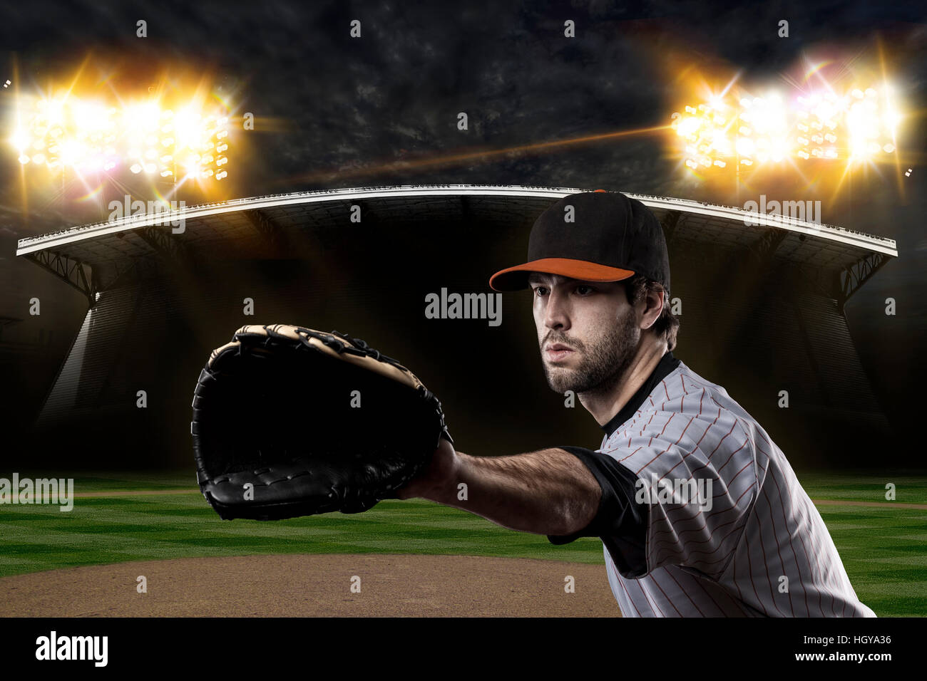 Baseball Player on a Orange Uniform on baseball Stadium Stock Photo - Alamy