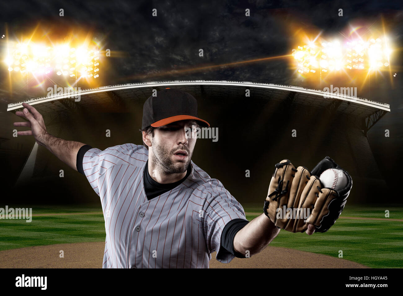 Baseball Player on a Orange Uniform on baseball Stadium Stock Photo - Alamy