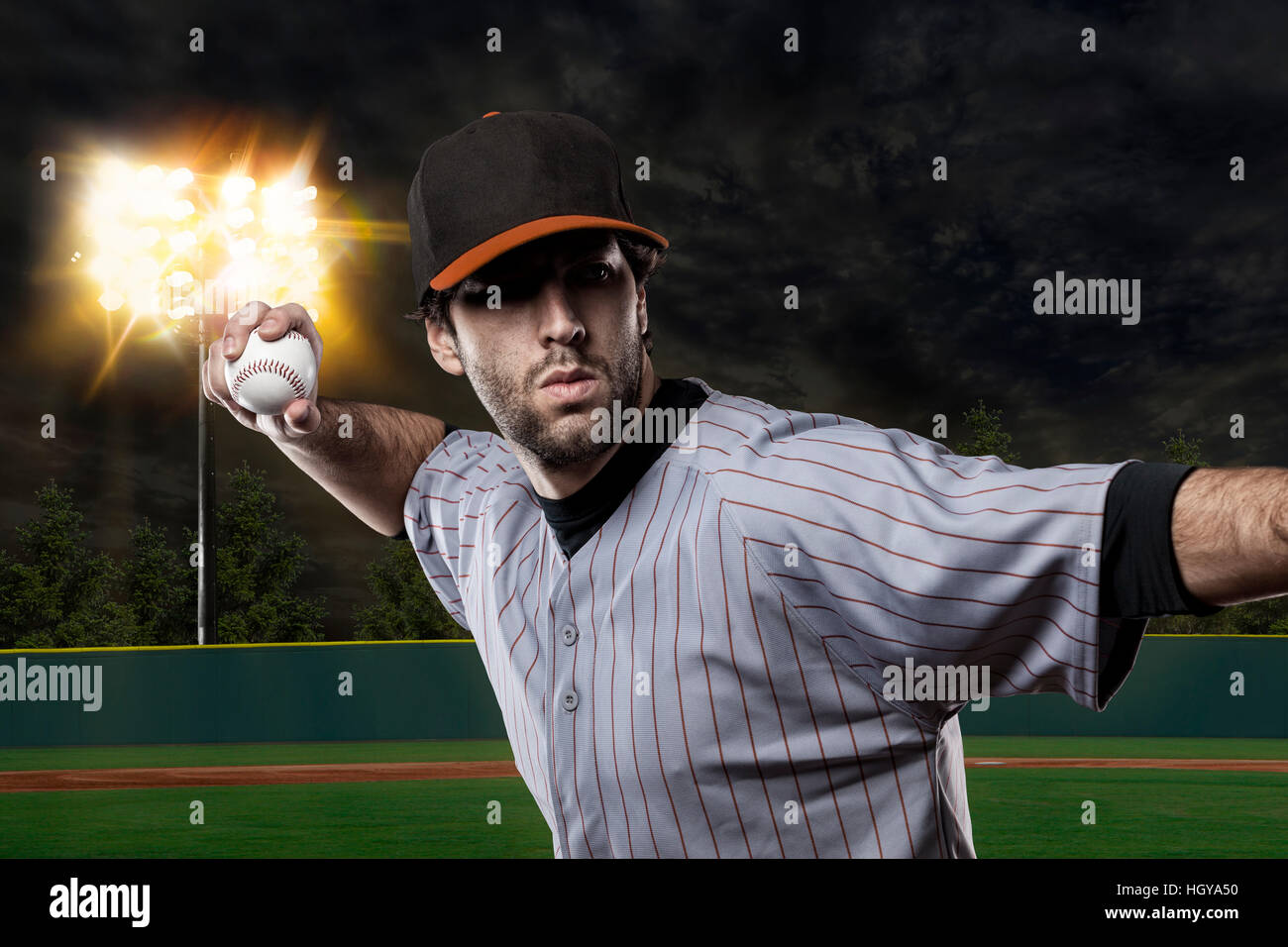 Baseball Player on a Orange Uniform on baseball Stadium Stock Photo - Alamy