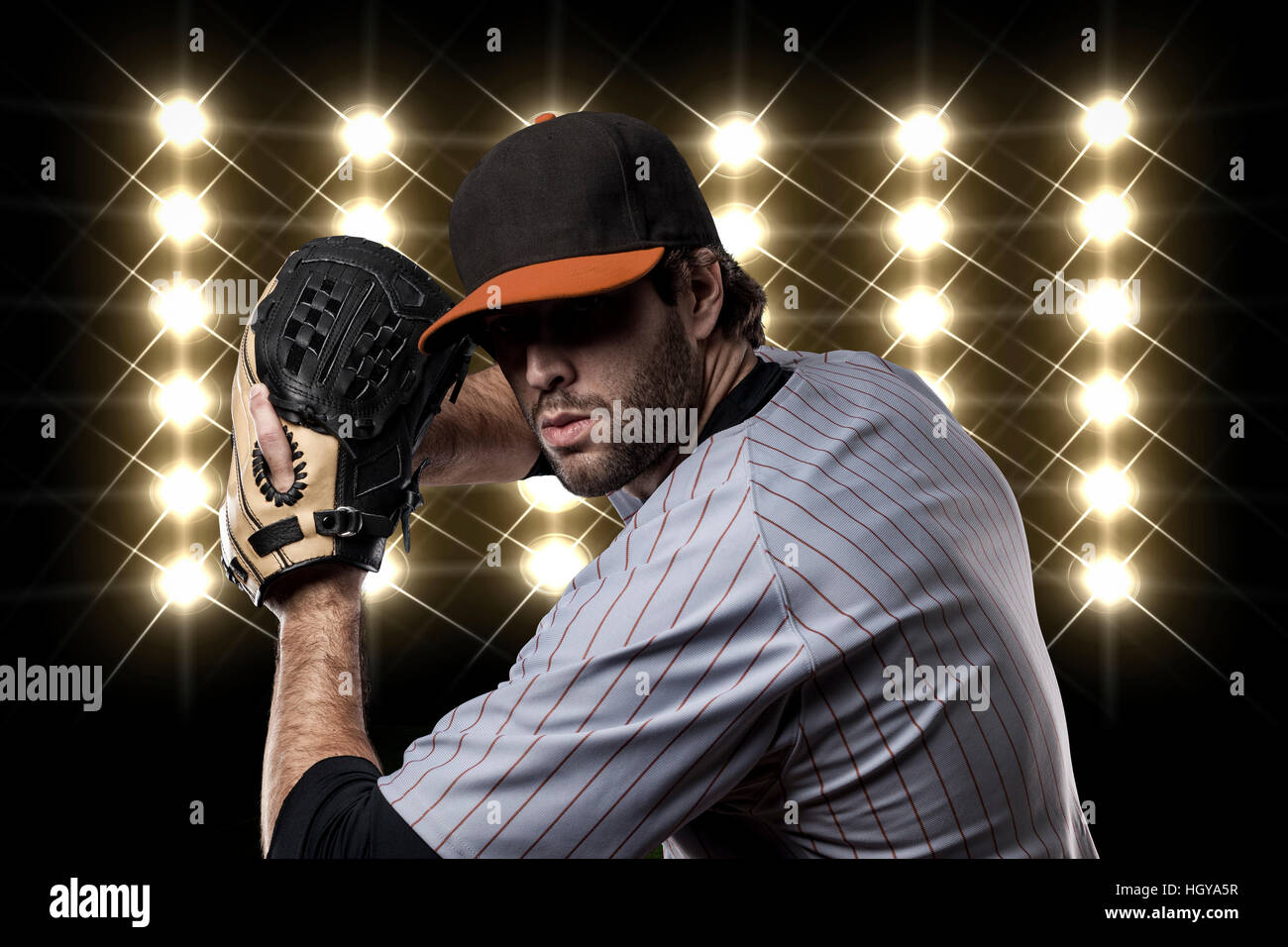 Baseball Player on a Orange Uniform on baseball Stadium Stock Photo - Alamy
