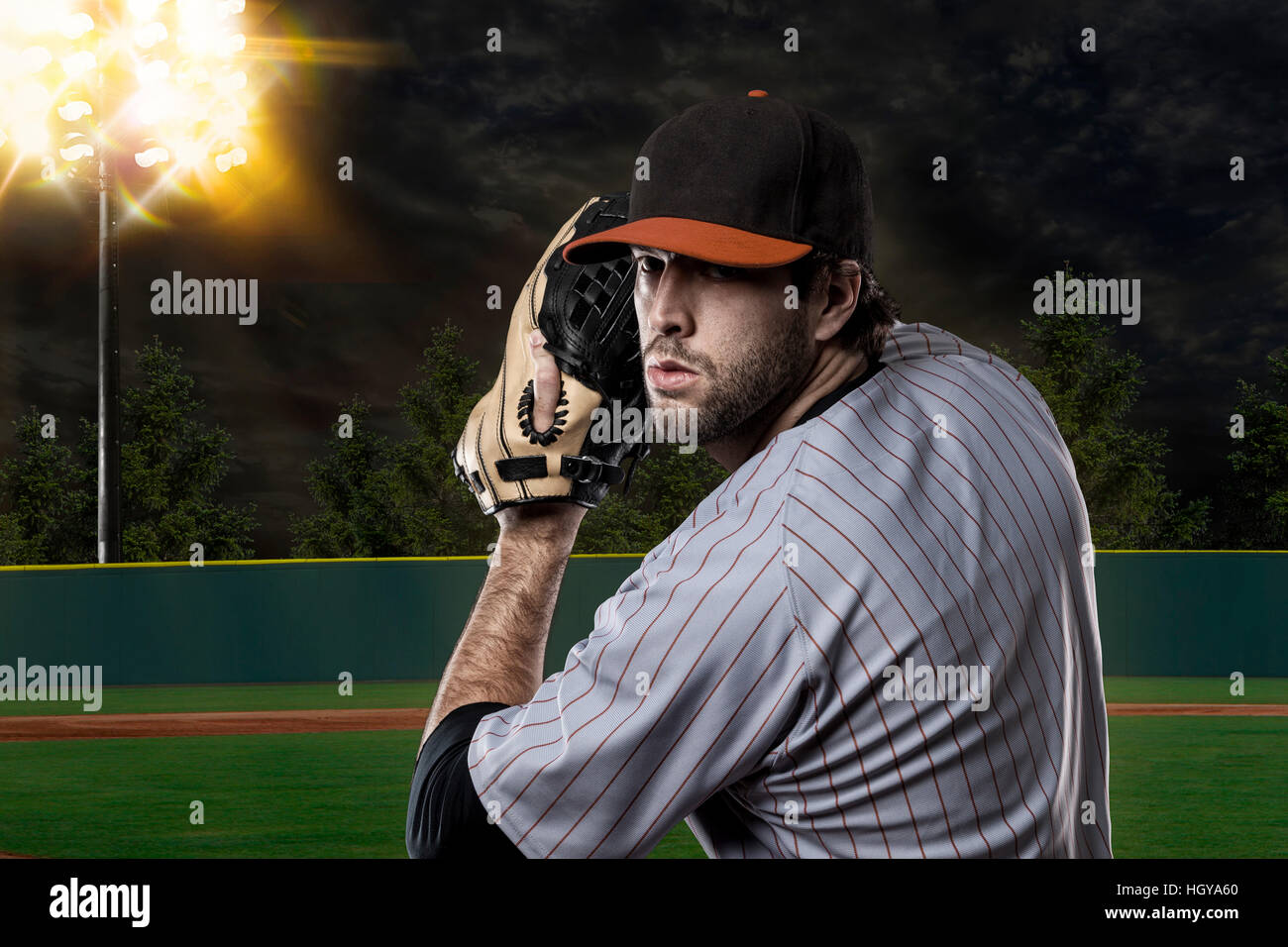 Baseball Player on a Orange Uniform on baseball Stadium Stock Photo - Alamy
