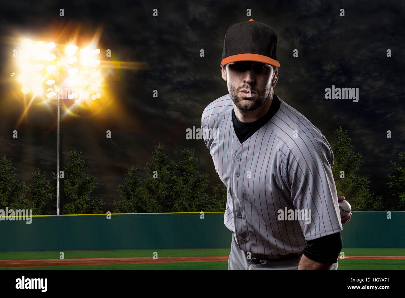 Baseball Player on a Orange Uniform on baseball Stadium Stock Photo - Alamy