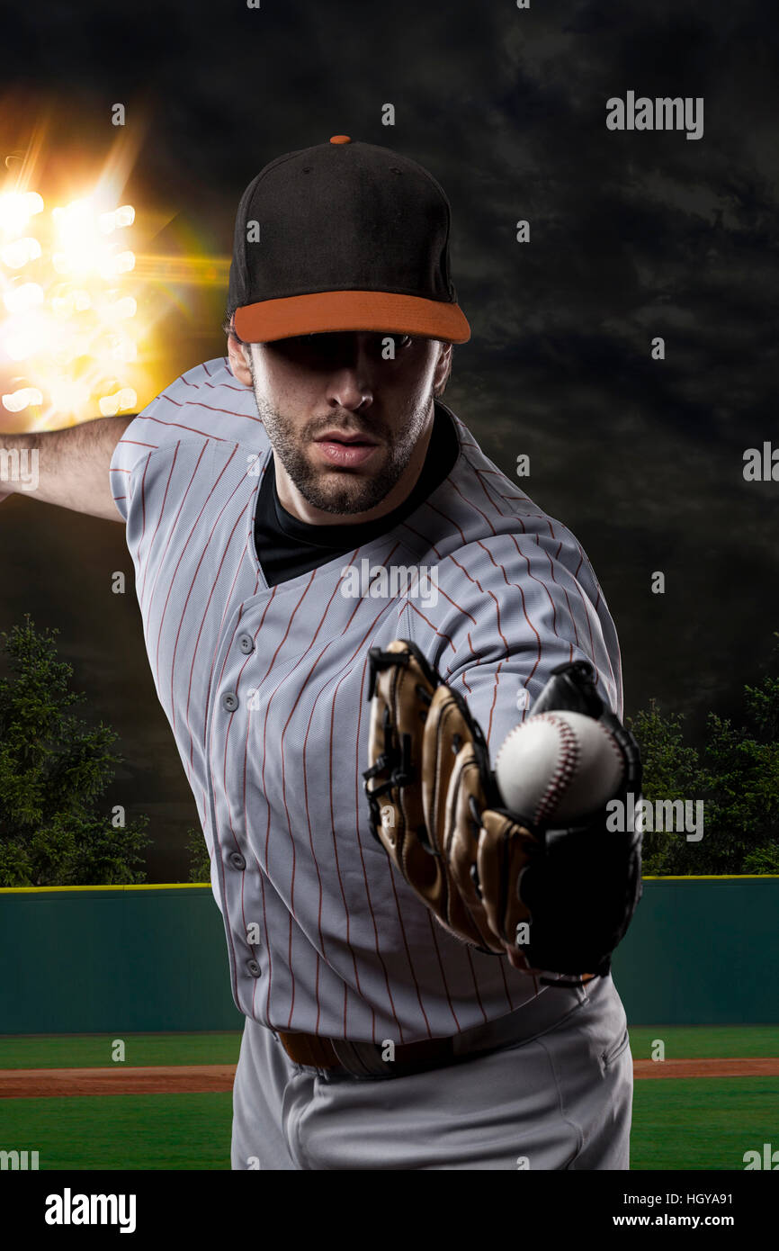 Baseball Player on a Orange Uniform on baseball Stadium Stock Photo - Alamy
