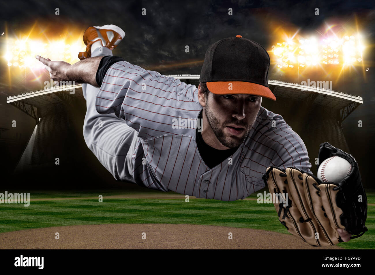 Baseball Player on a Orange Uniform on baseball Stadium Stock Photo - Alamy