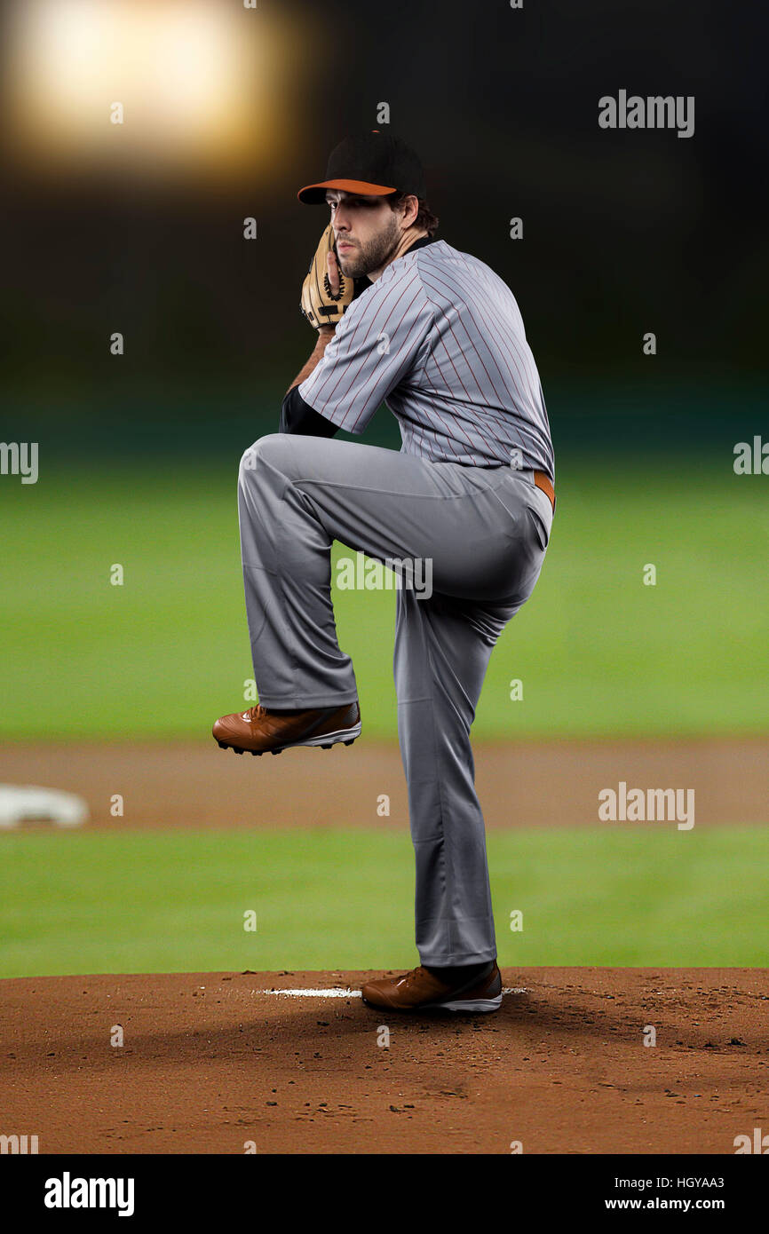 Pitcher Baseball Player on a Orange Uniform on baseball Stadium Stock ...