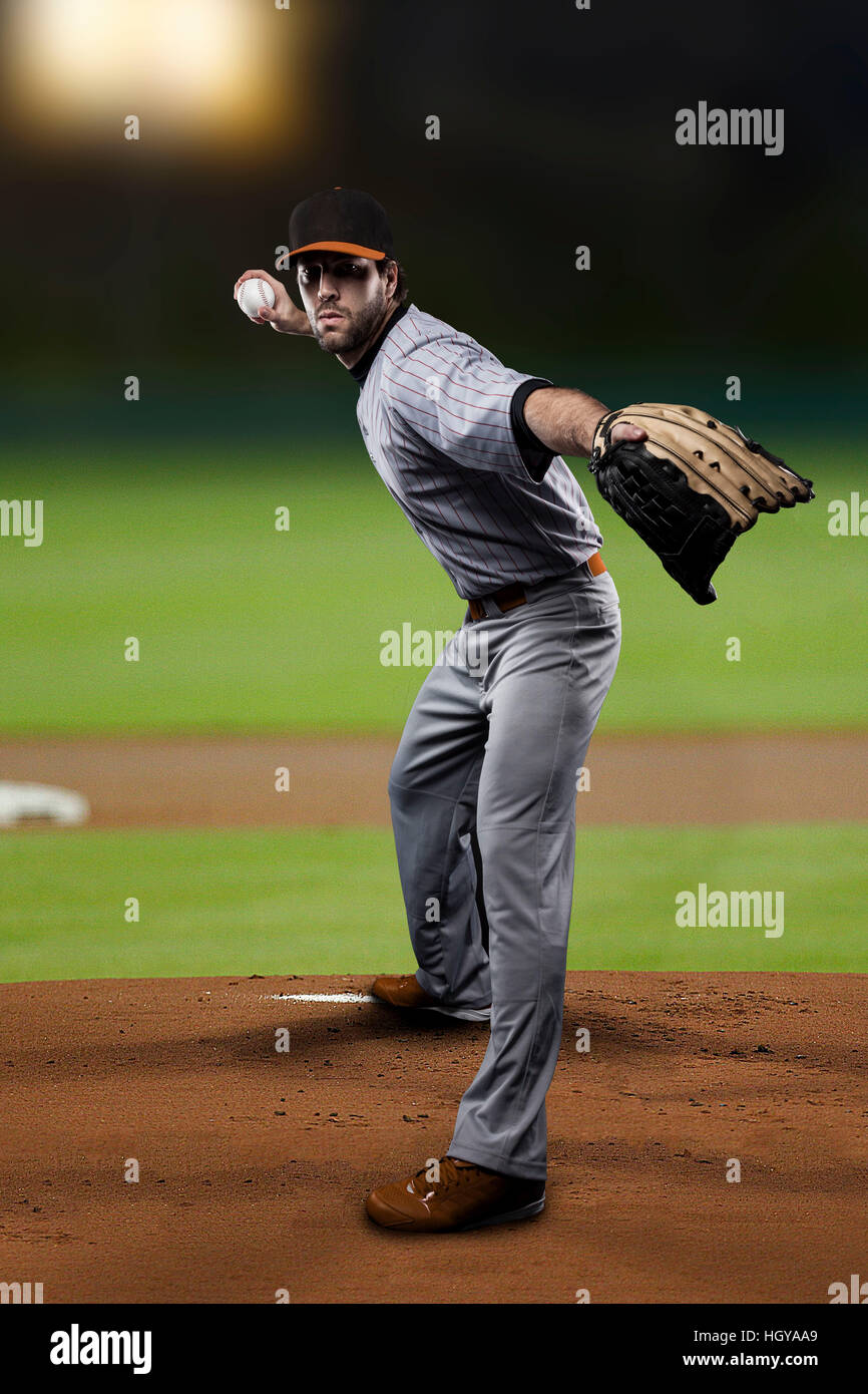 Pitcher Baseball Player on a Orange Uniform on baseball Stadium Stock ...