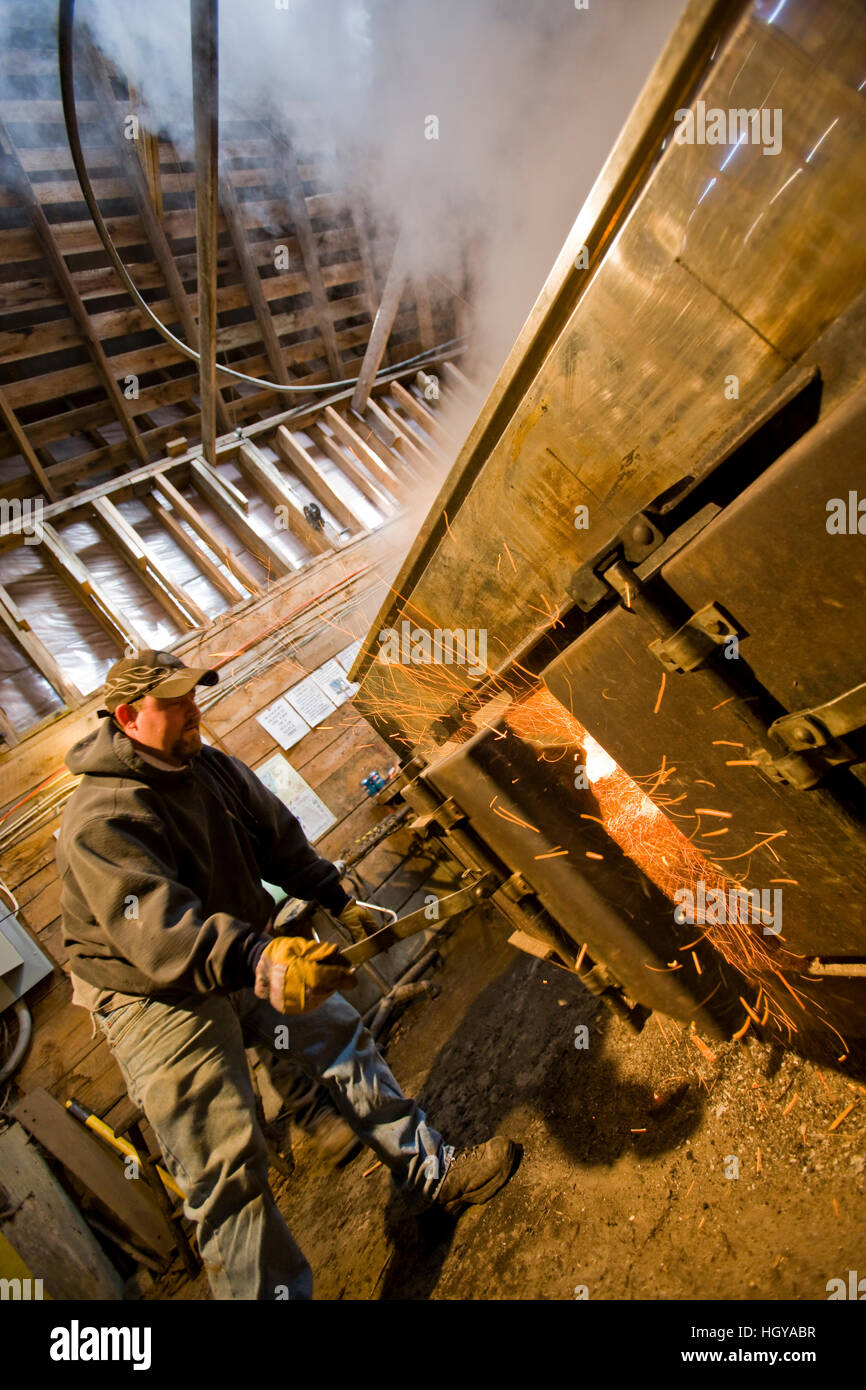 Ralph Luce stoking the fire in the sap evaporator in his sugar house at ...