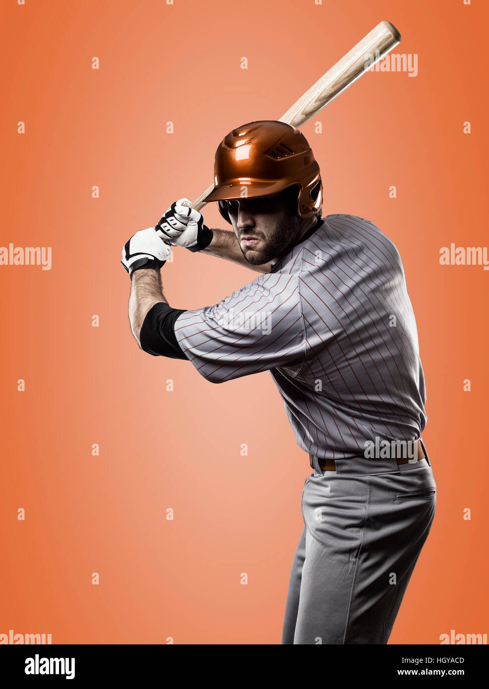 Baseball Player on a orange Uniform on orange background Stock Photo ...