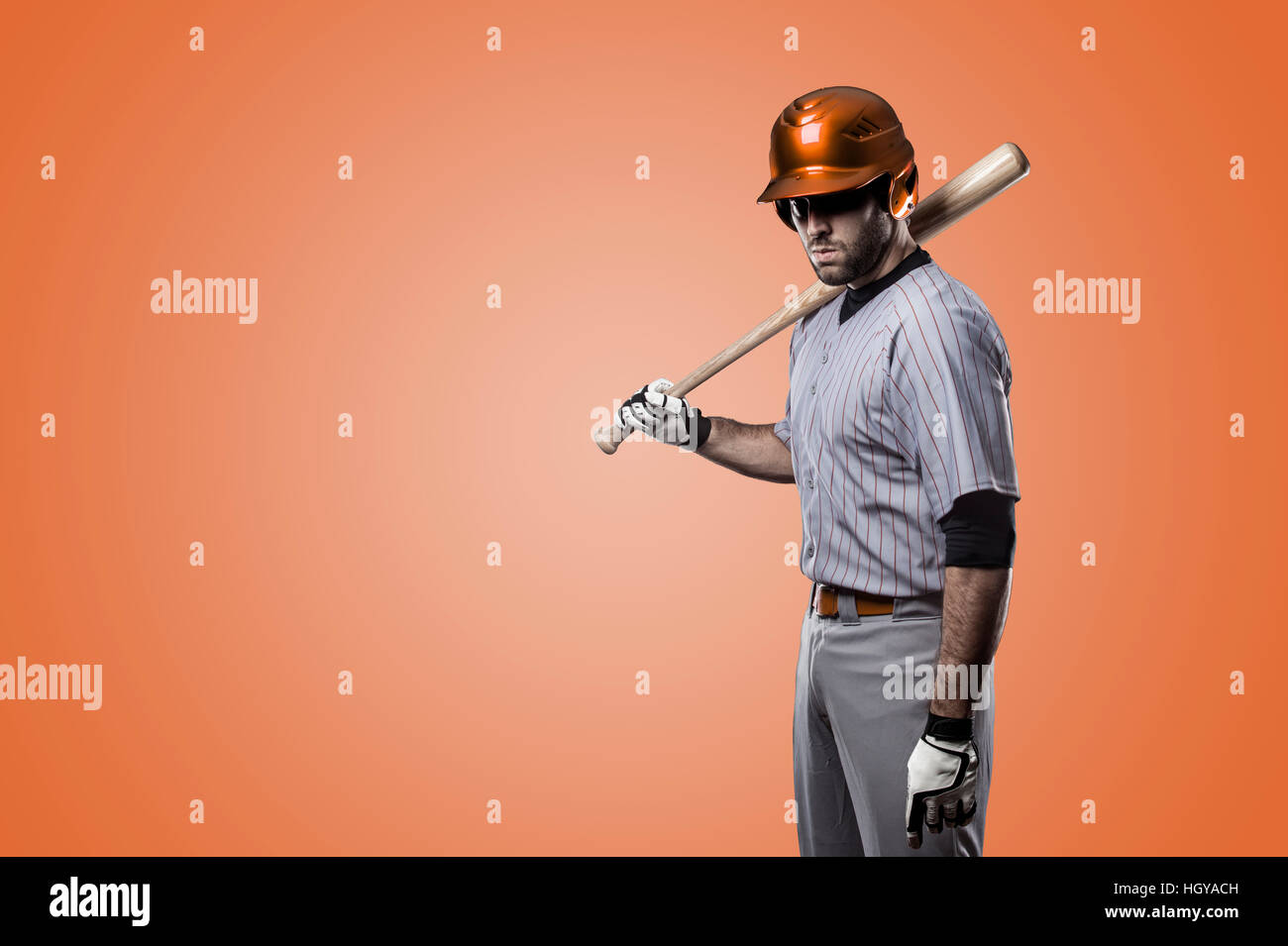 Baseball Player on a orange Uniform on orange background Stock Photo ...