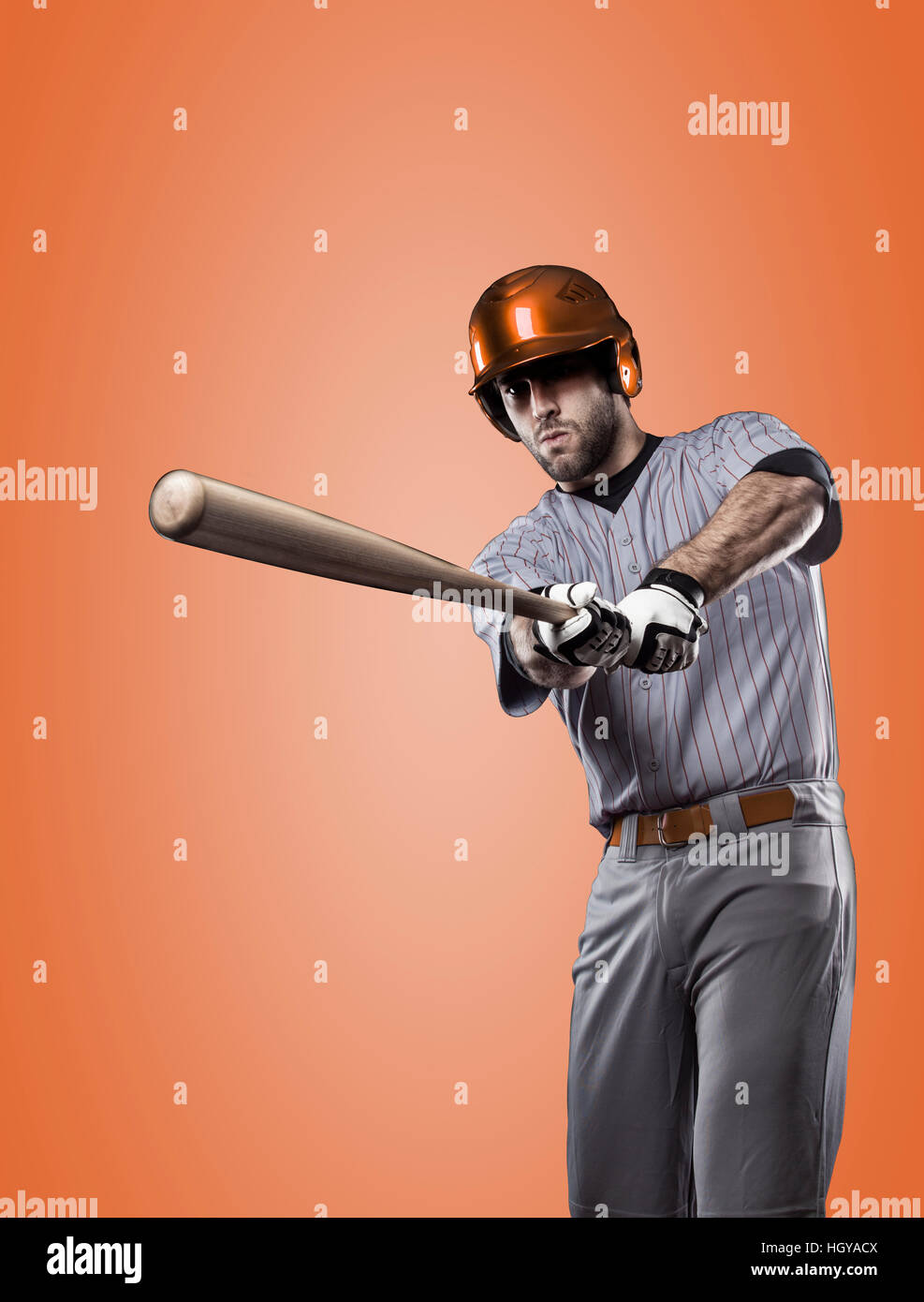 Baseball Player on a orange Uniform on orange background Stock Photo ...