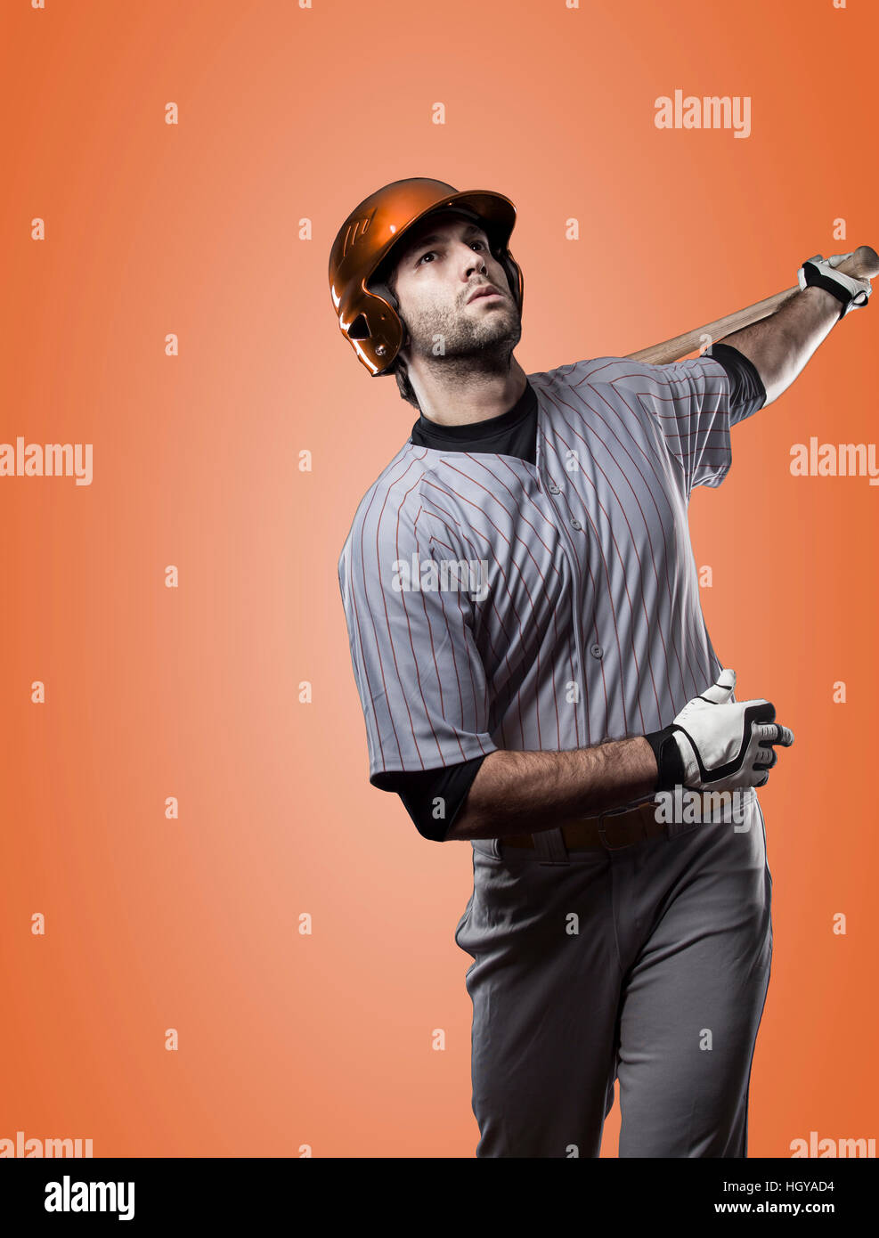 Baseball Player on a orange Uniform on orange background Stock Photo ...