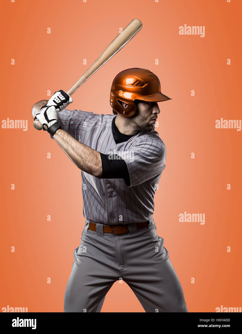 Baseball Player on a orange Uniform on orange background Stock Photo ...