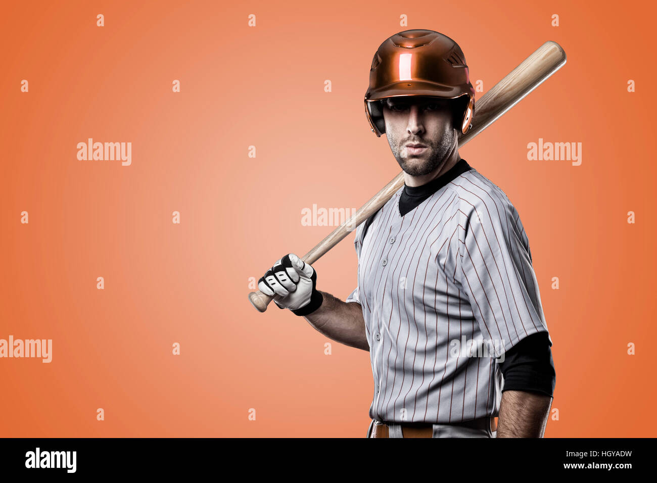Baseball Player on a orange Uniform on orange background Stock Photo ...