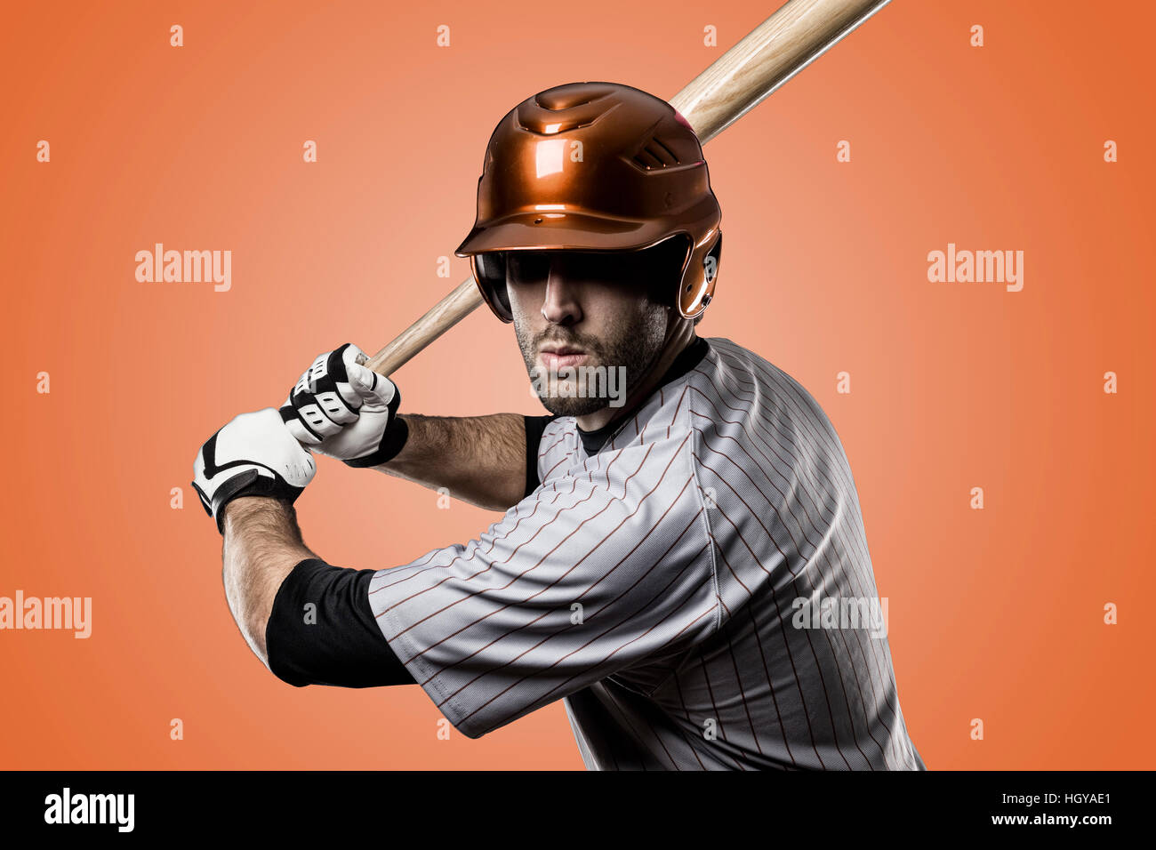 Baseball Player on a orange Uniform on orange background Stock Photo ...