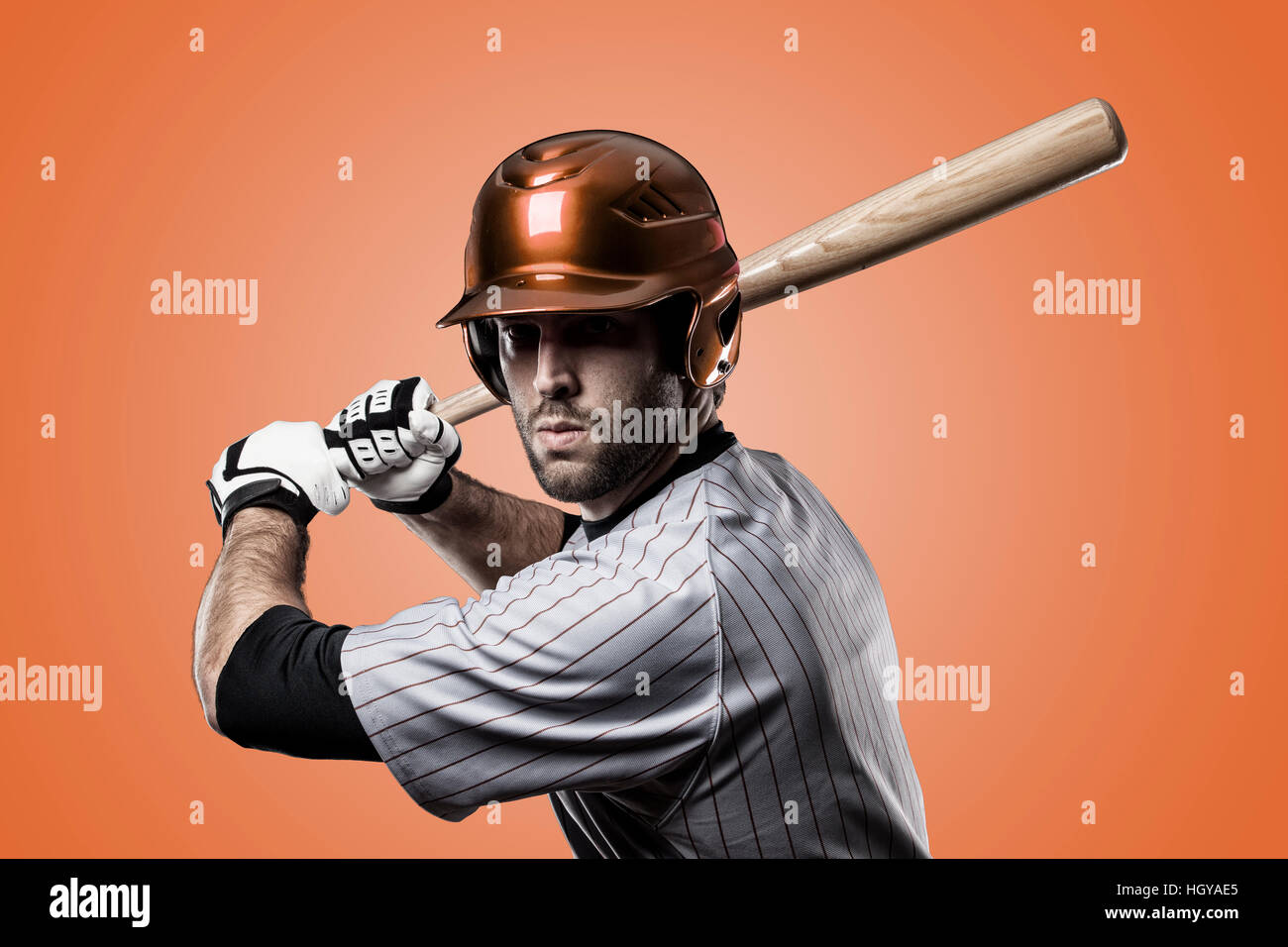 Baseball Player on a orange Uniform on orange background Stock Photo ...