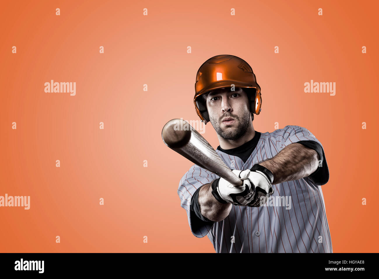 Baseball Player on a orange Uniform on orange background Stock Photo ...