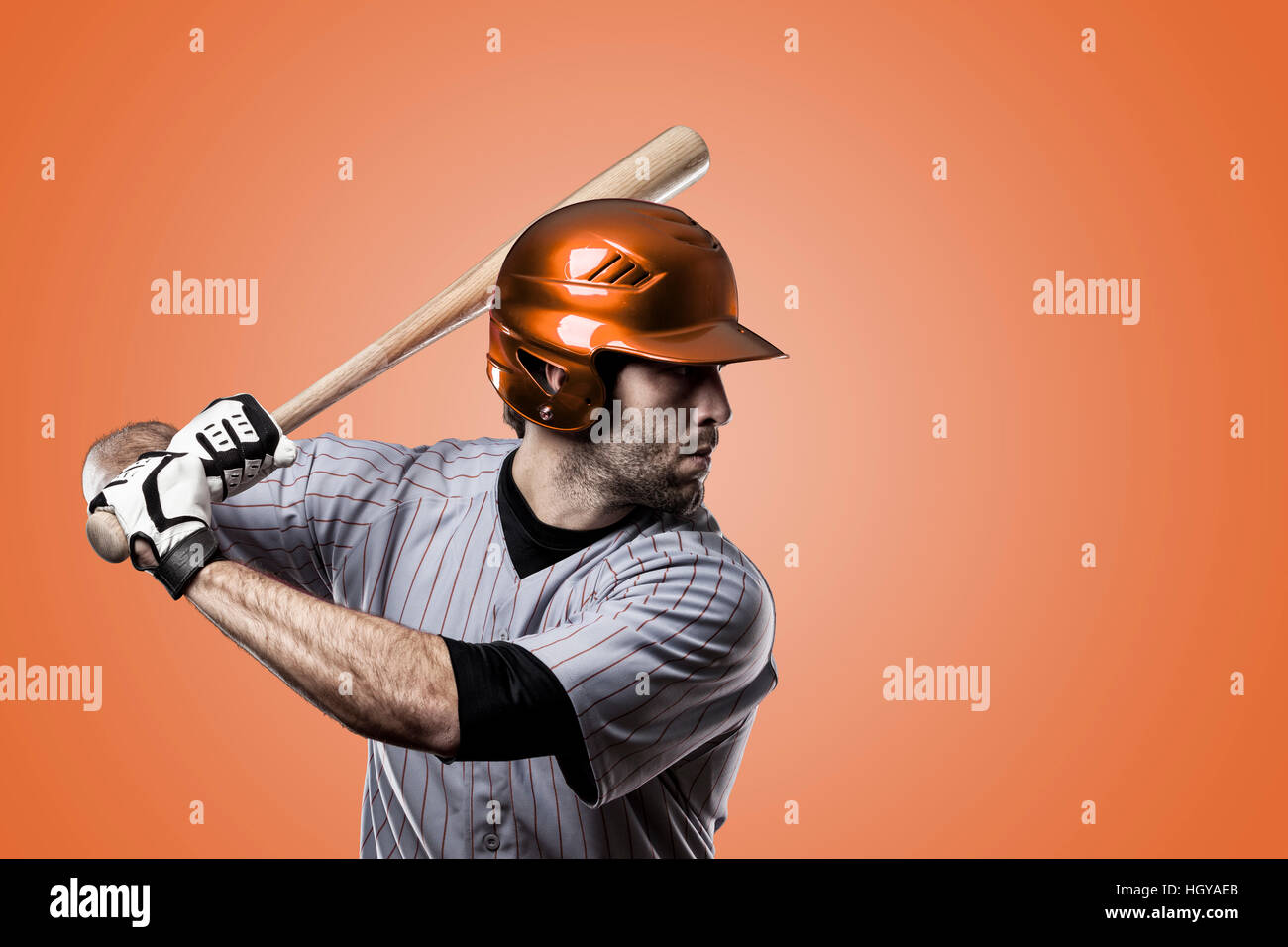 Baseball Player on a orange Uniform on orange background Stock Photo ...