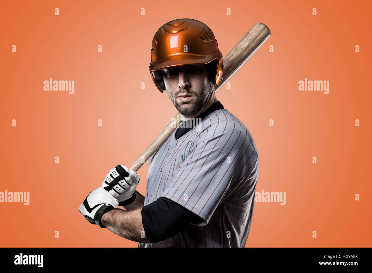 Baseball Player on a orange Uniform on orange background Stock Photo ...