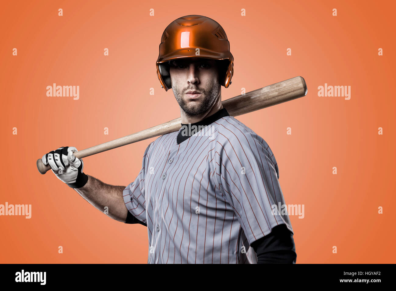 Baseball Player on a orange Uniform on orange background Stock Photo ...