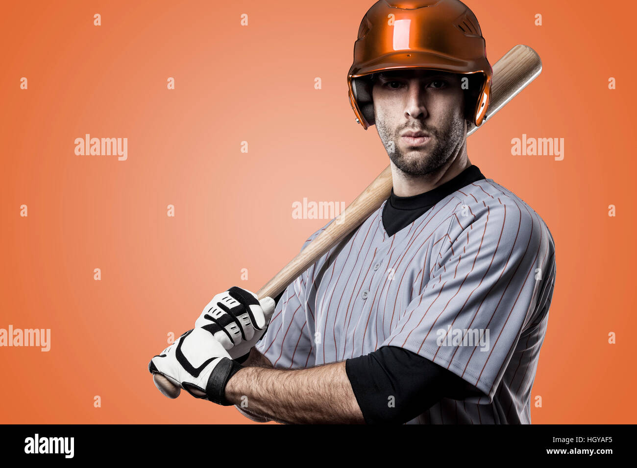 Baseball Player on a orange Uniform on orange background Stock Photo ...