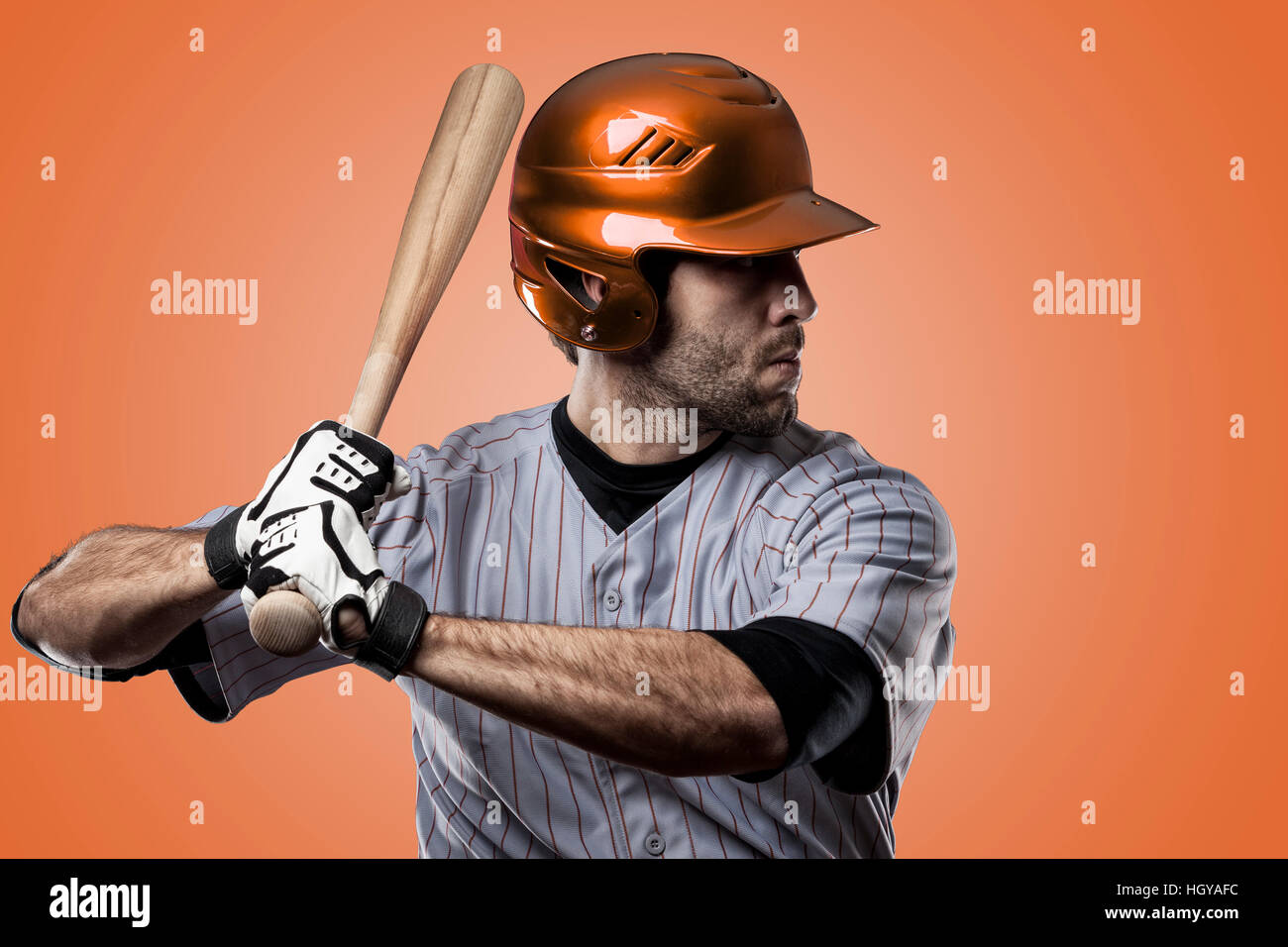 Baseball Player on a orange Uniform on orange background Stock Photo ...