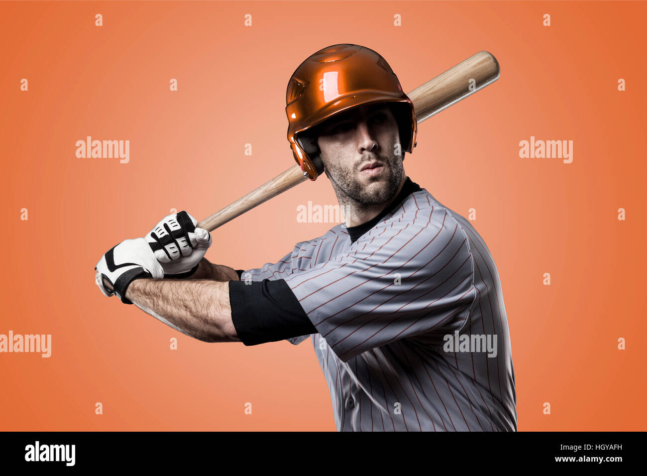 Baseball Player on a orange Uniform on orange background Stock Photo ...