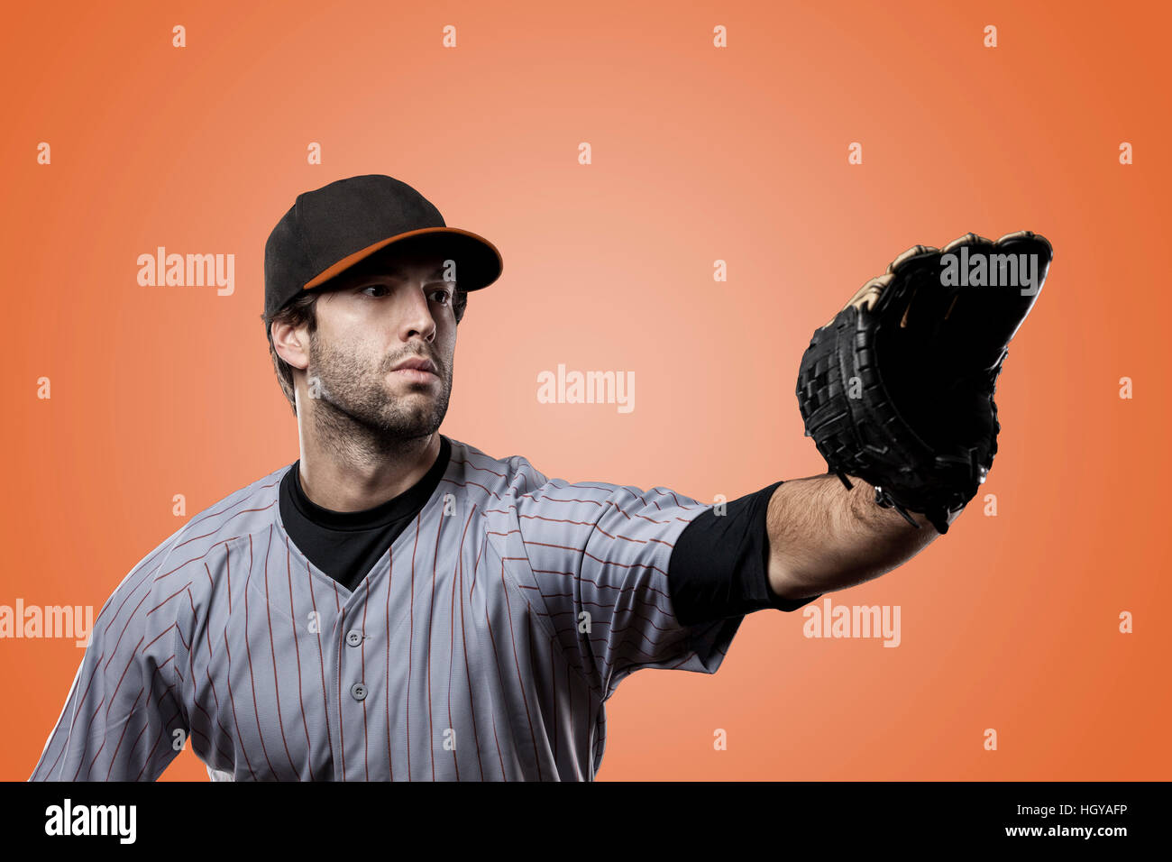 Baseball Player on a orange Uniform on orange background Stock Photo ...