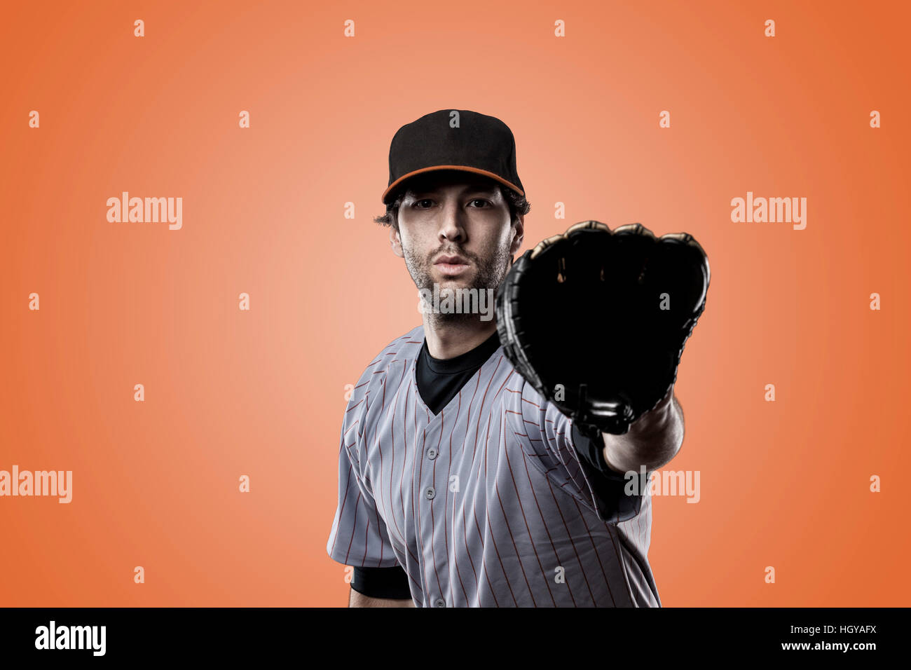 Baseball Player on a orange Uniform on orange background Stock Photo ...
