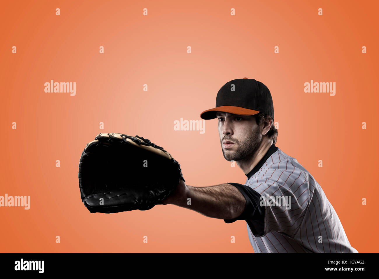 Baseball Player on a orange Uniform on orange background Stock Photo ...