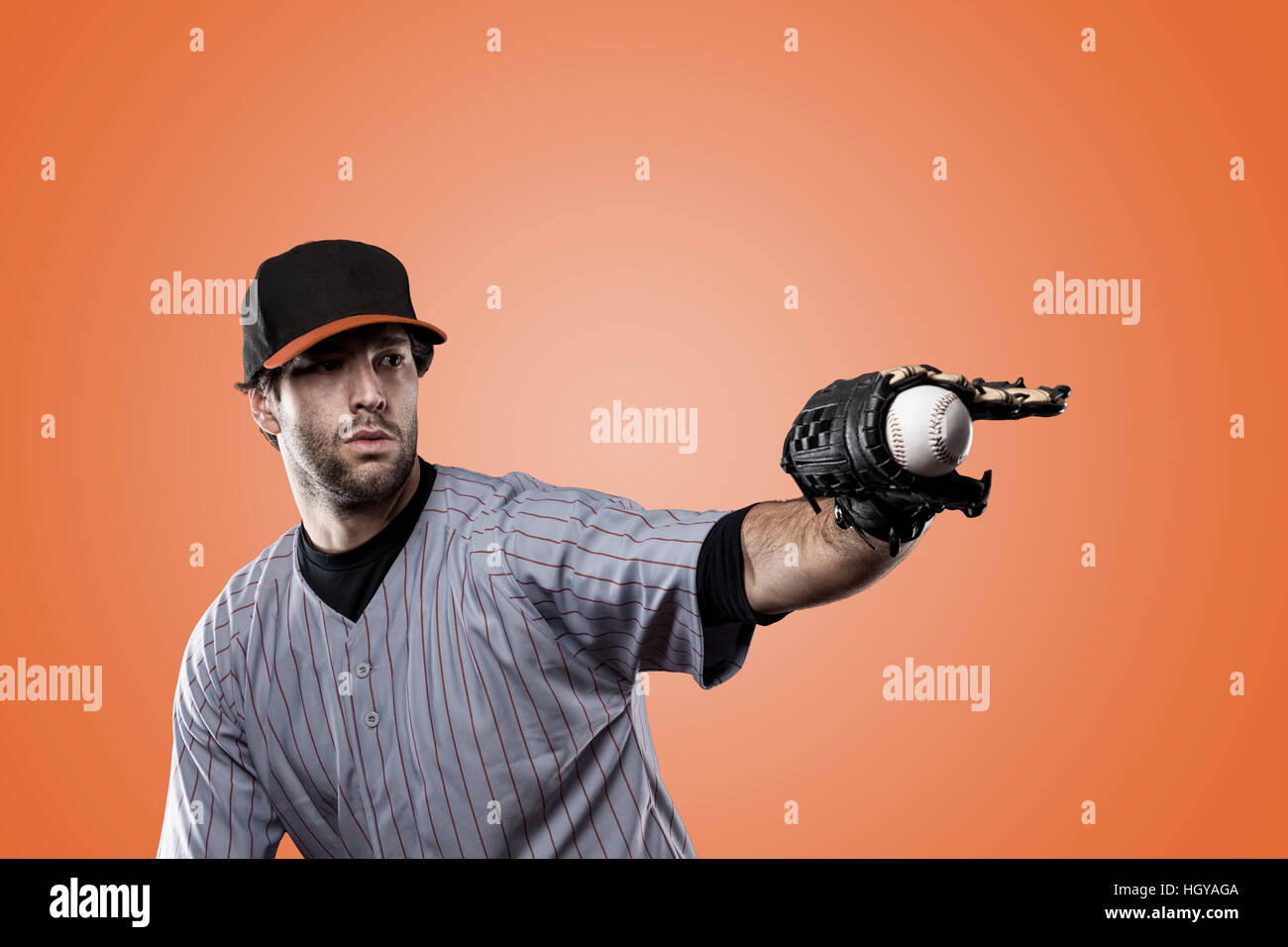 Baseball Player on a orange Uniform on orange background Stock Photo ...