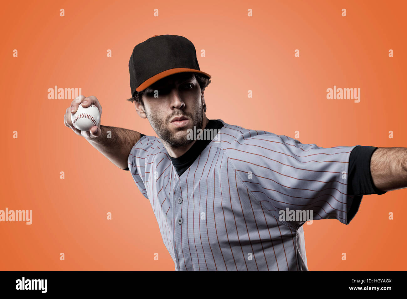 Baseball Player on a orange Uniform on orange background Stock Photo ...