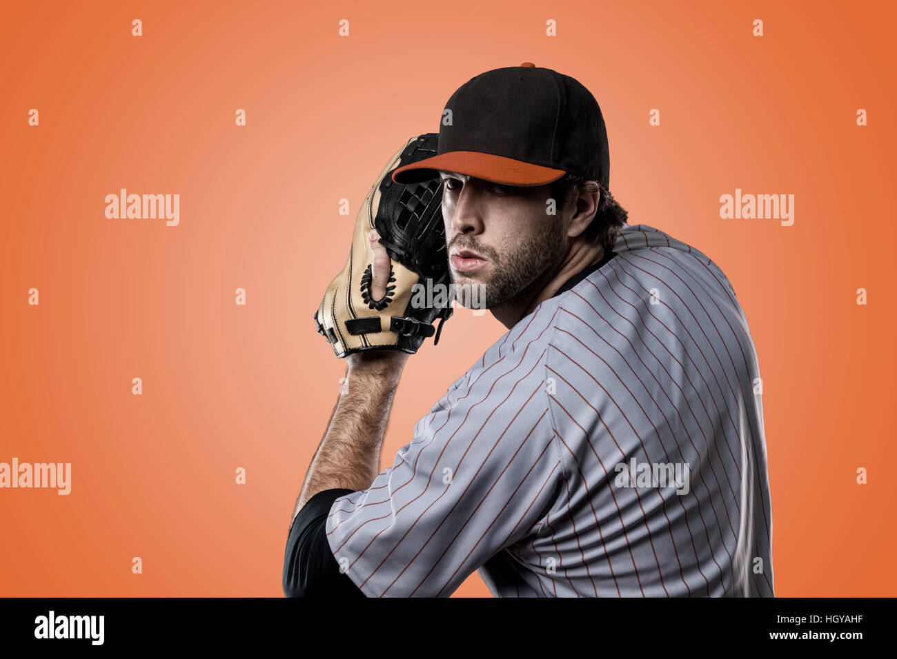Baseball Player on a orange Uniform on orange background Stock Photo ...