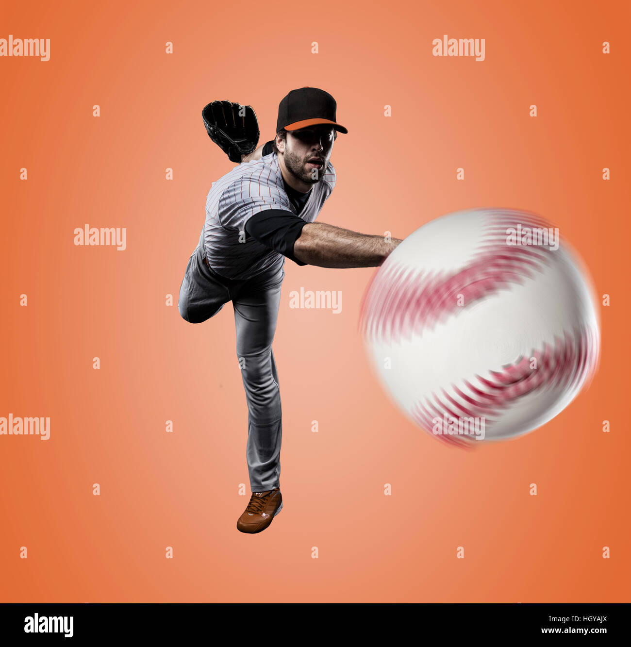 Pitcher Baseball Player on a orange Uniform on orange background Stock ...