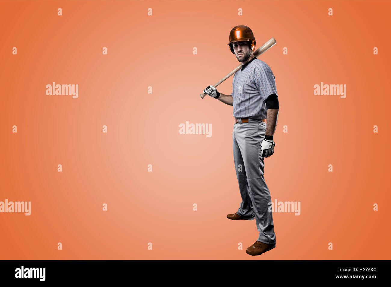 Baseball Player on a orange Uniform on orange background Stock Photo ...