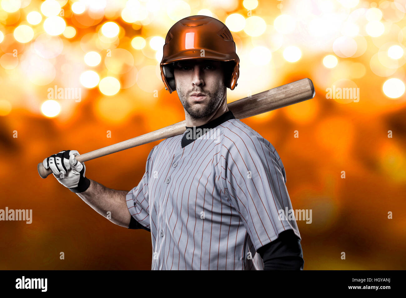 Baseball Player on a orange Uniform on orange lights background Stock ...