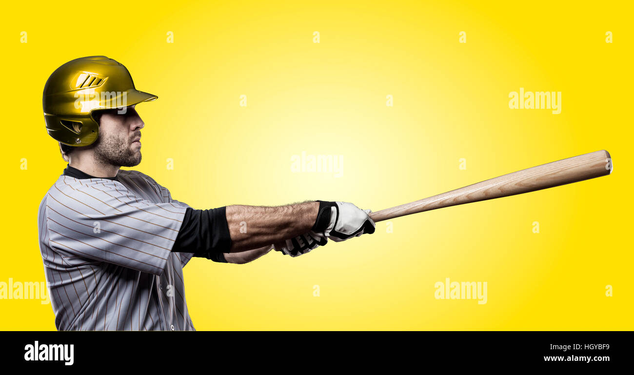 Baseball Player on a yellow Uniform on yellow background Stock Photo ...