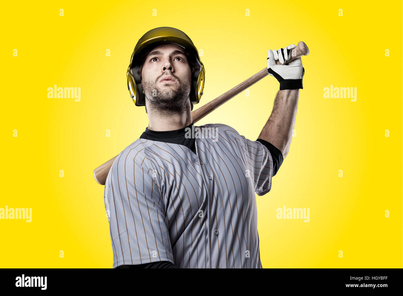 Baseball Player on a yellow Uniform on yellow background Stock Photo ...