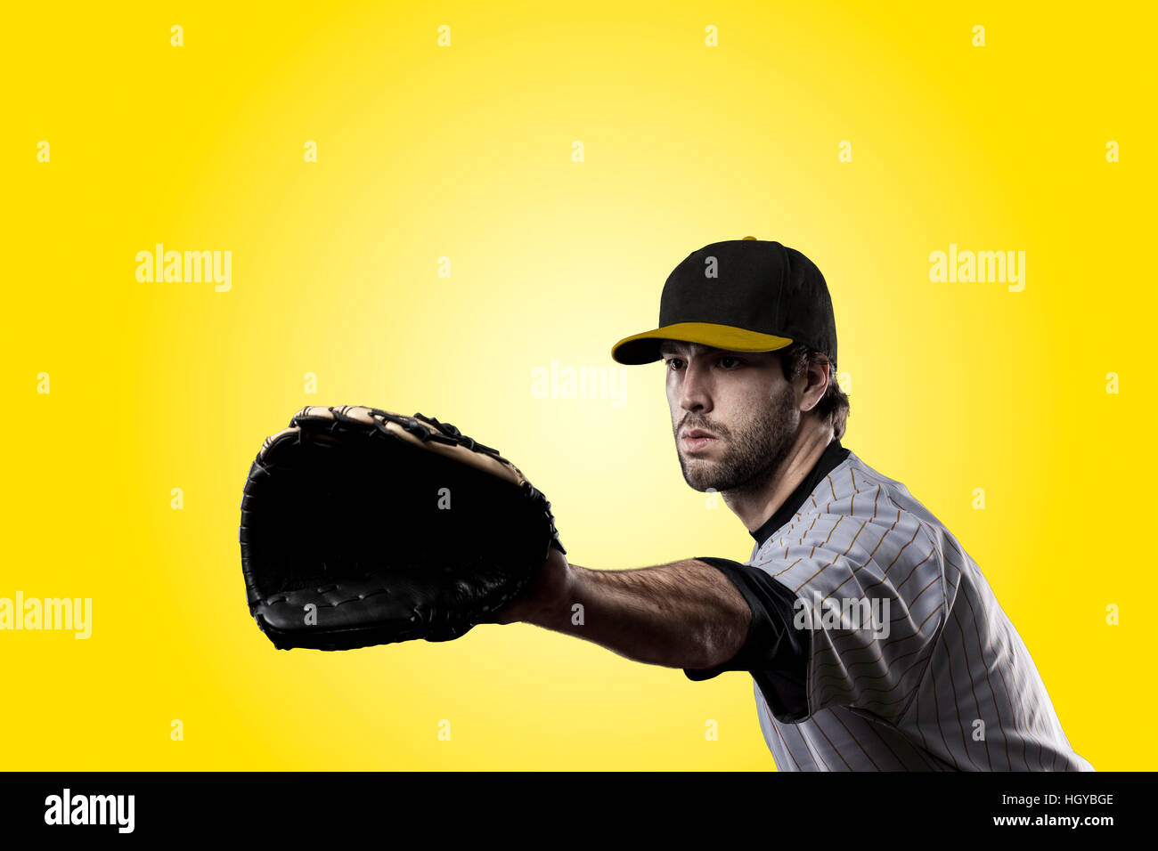 Baseball Player on a yellow Uniform on yellow background Stock Photo ...
