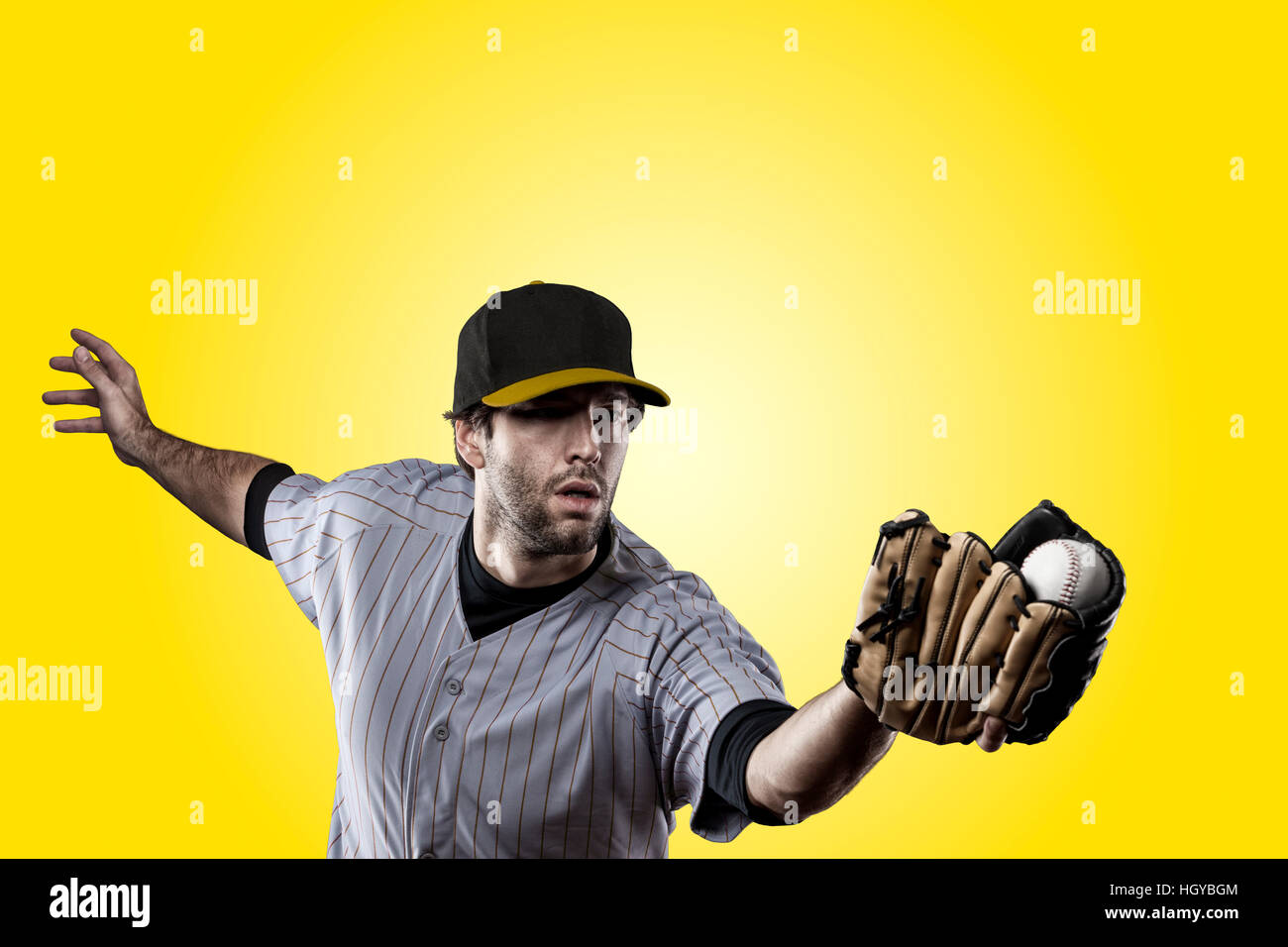 Baseball Player on a yellow Uniform on yellow background Stock Photo ...