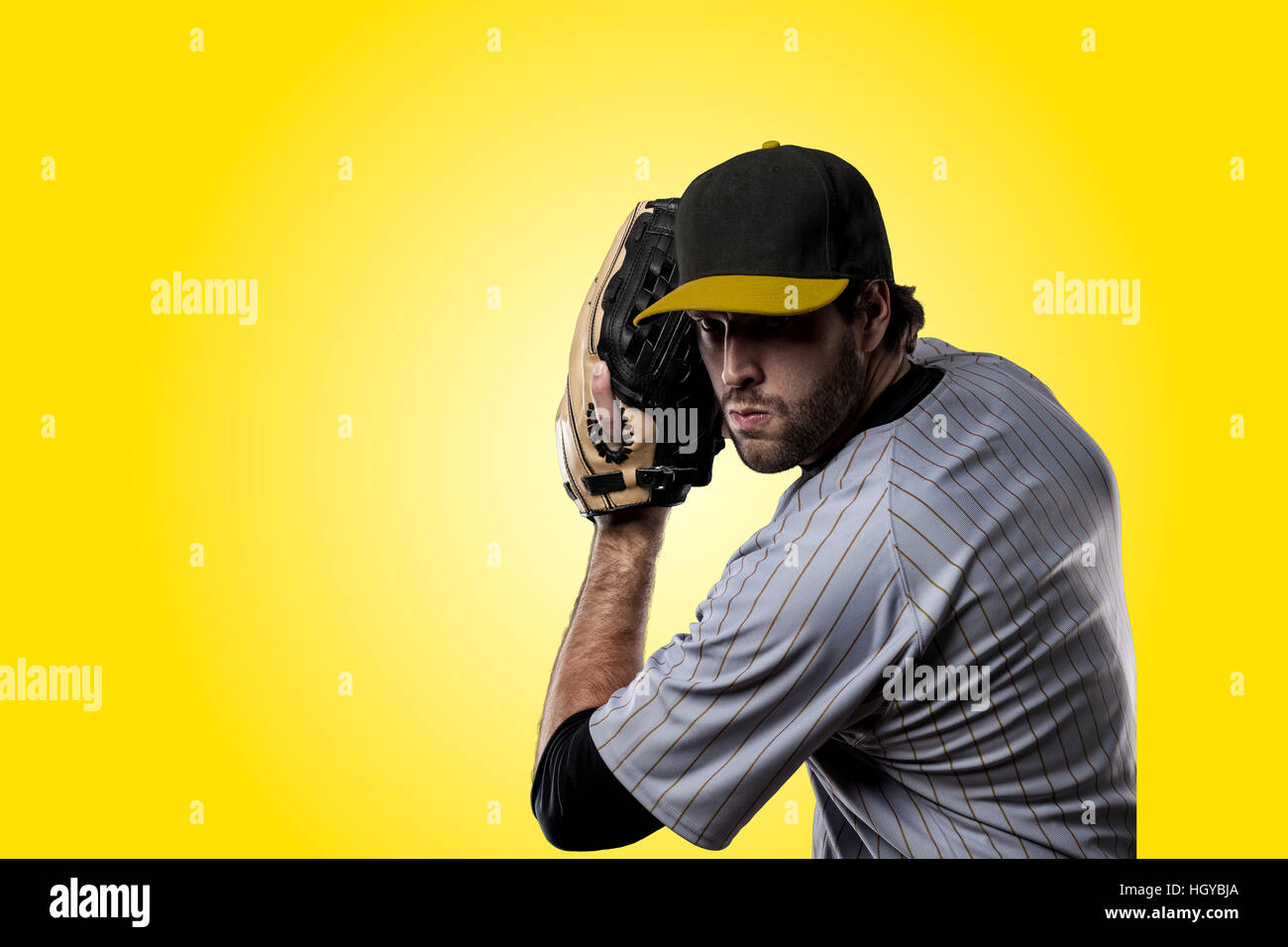 Baseball Player on a yellow Uniform on yellow background Stock Photo ...