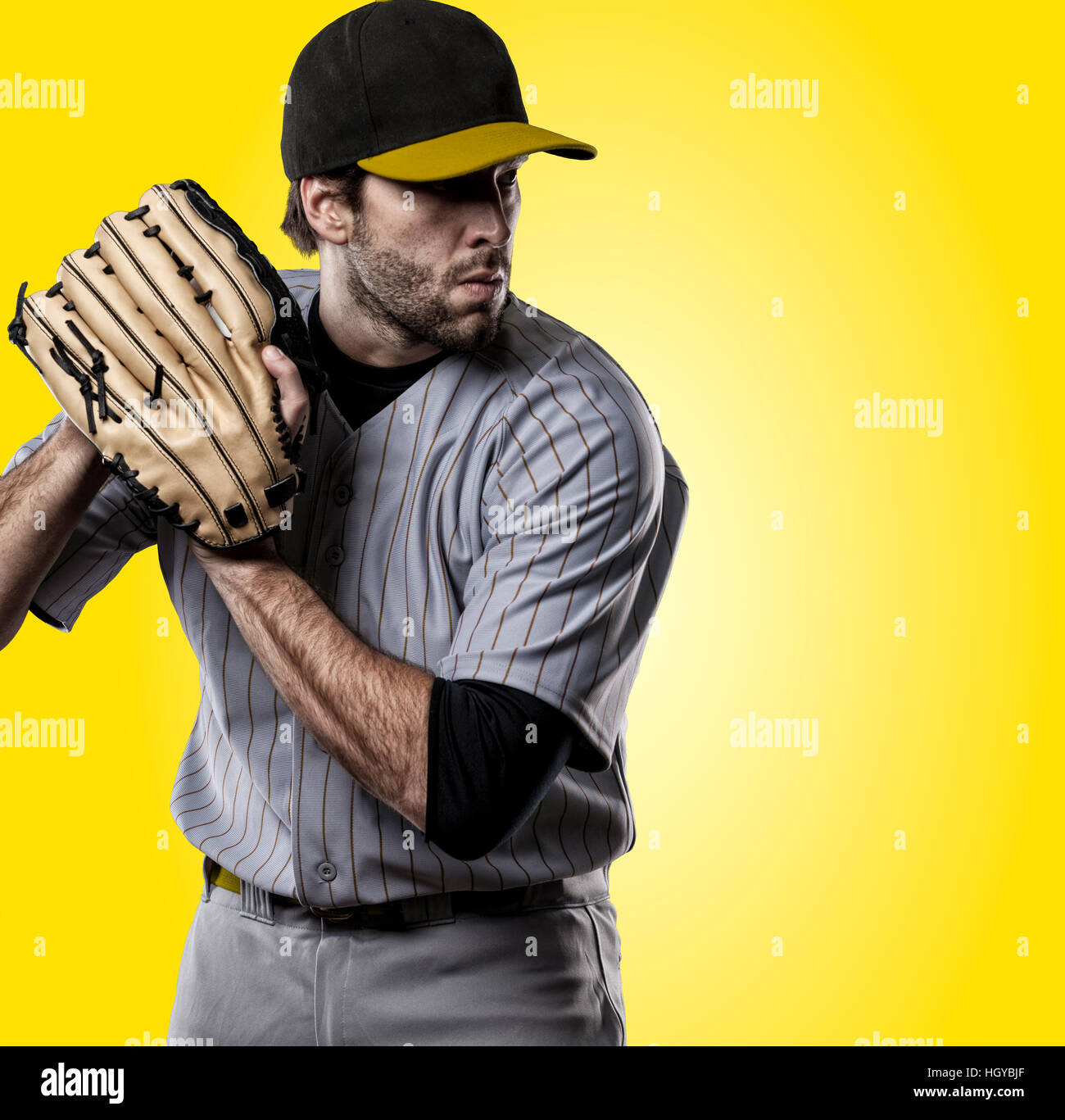 Baseball Player on a yellow Uniform on yellow background Stock Photo ...