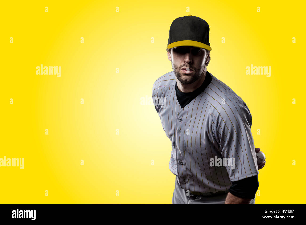 Baseball Player on a yellow Uniform on yellow background Stock Photo ...