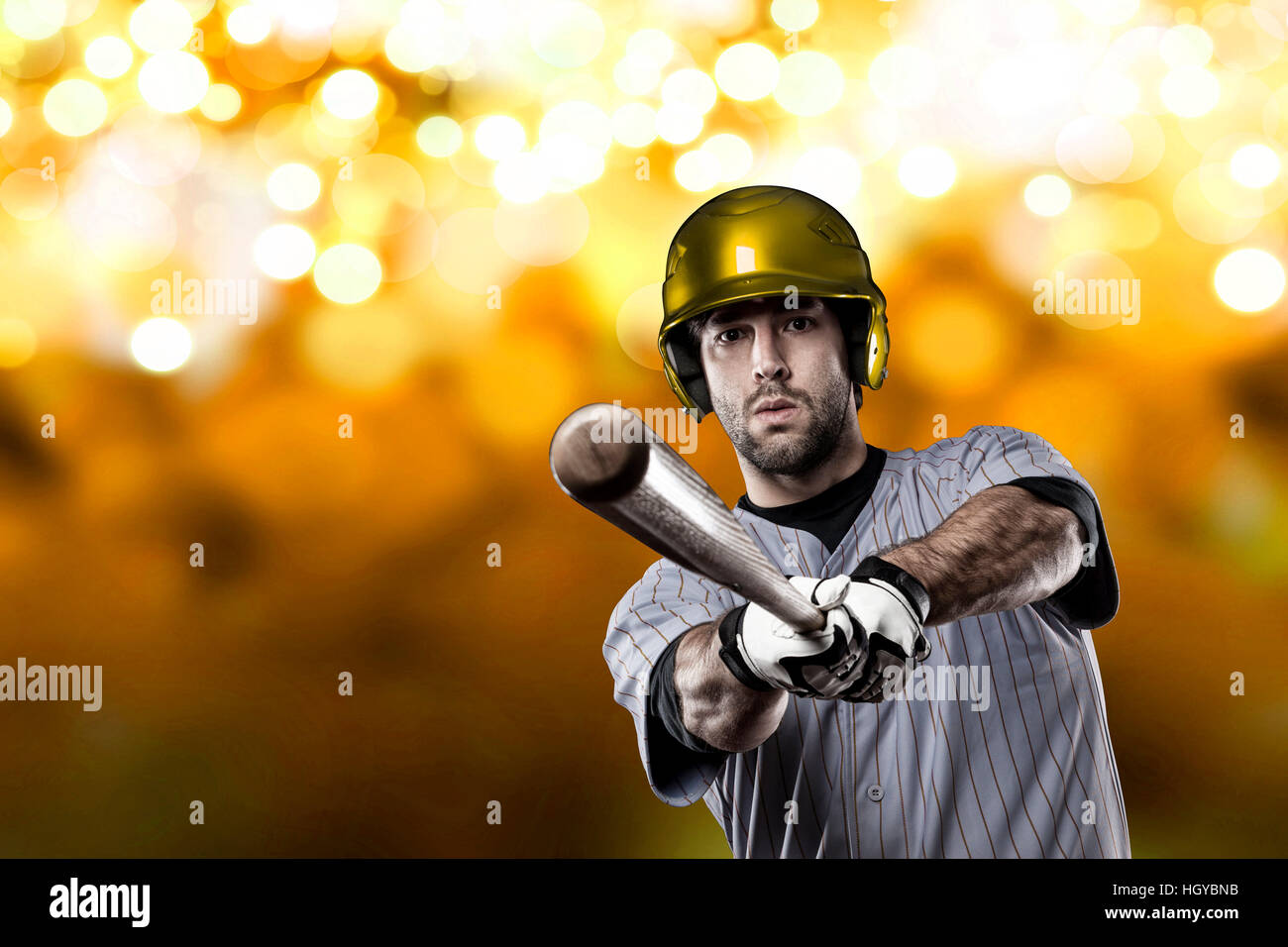 Baseball Player on a yellow Uniform on yellow lights background Stock ...